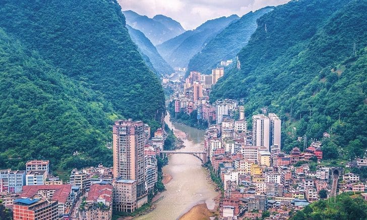 Unique City In China Between Mountains And Polluted Brown River